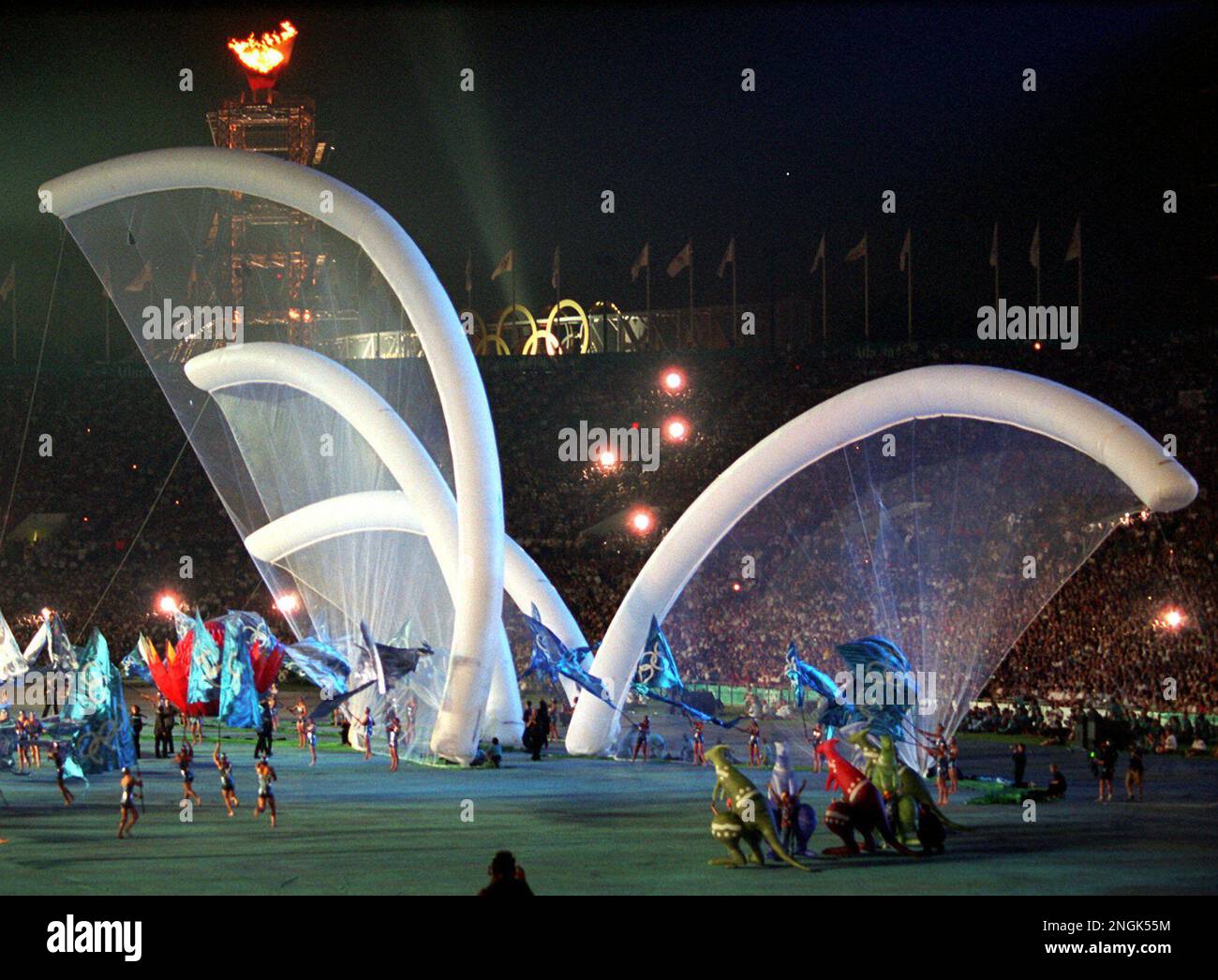 Performers depict a scene featuring the Sydney Opera House during the ...