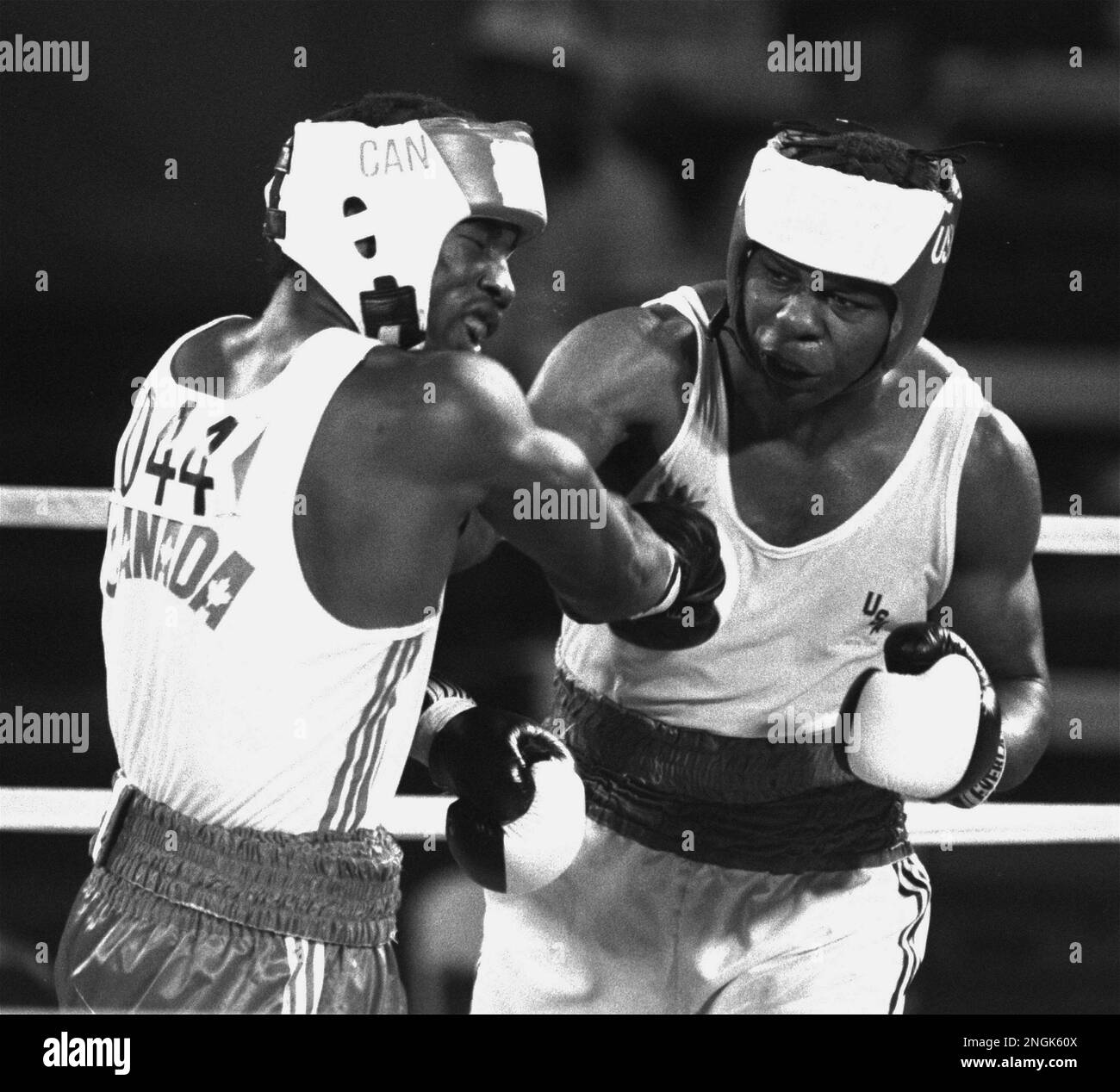 U.S. Olympic boxer Tyrell Biggs from Philadelphia, Pa., right, leans ...
