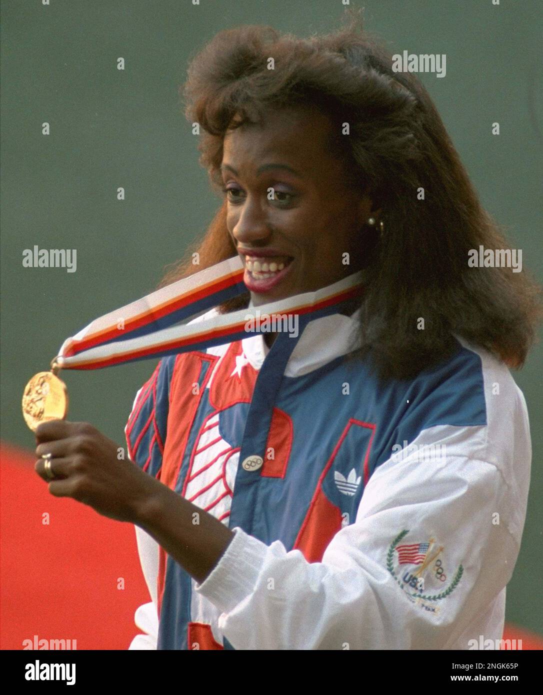 Jackie Joyner-Kersee proudly waves her second gold medal of the 1988 ...