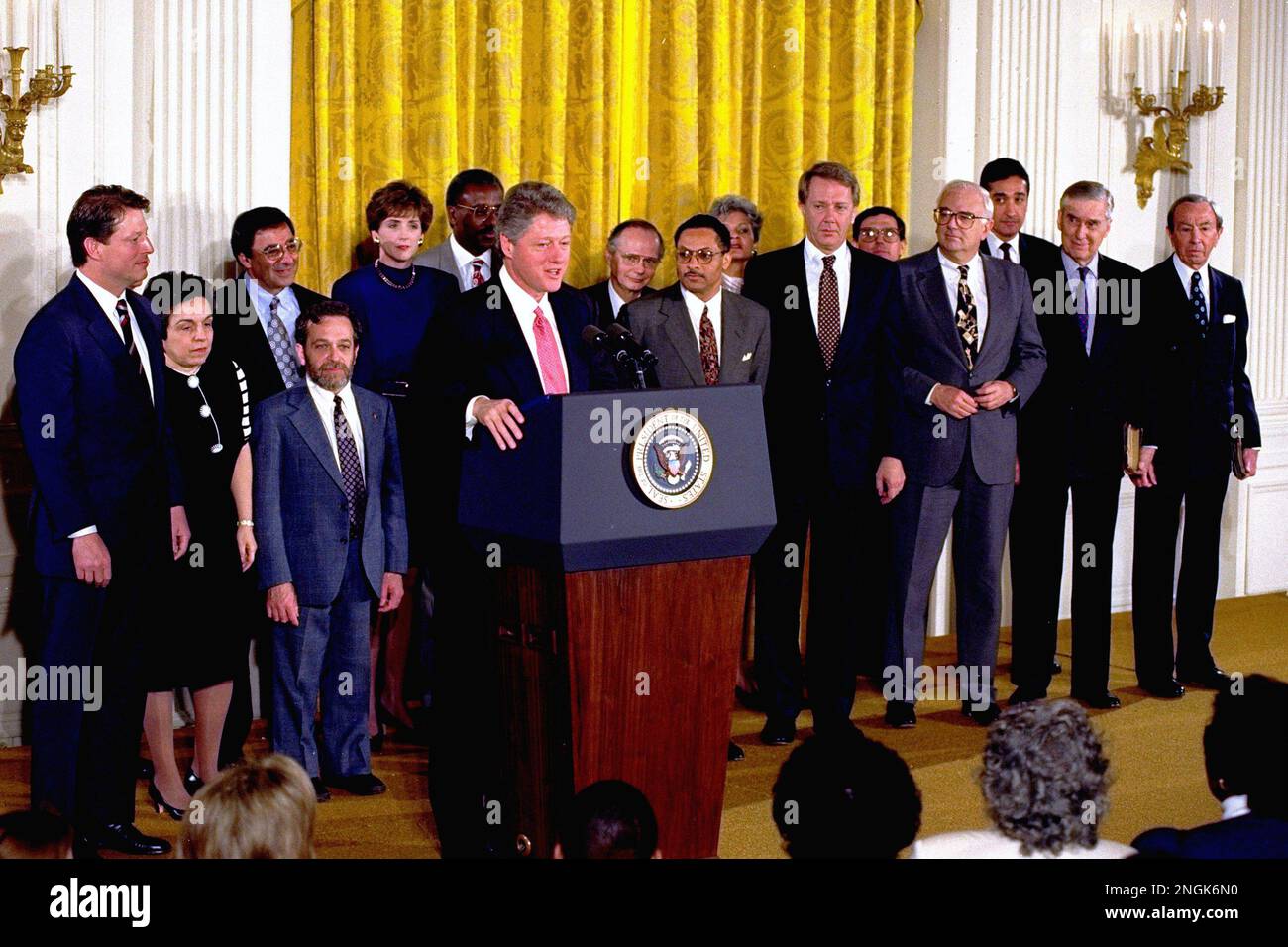President Clinton speaks as members of his Cabinet stand behind him at ...