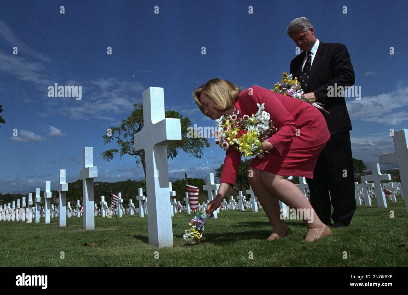 U.S. First Lady Hillary Rodham Clinton places flowers on one of the ...