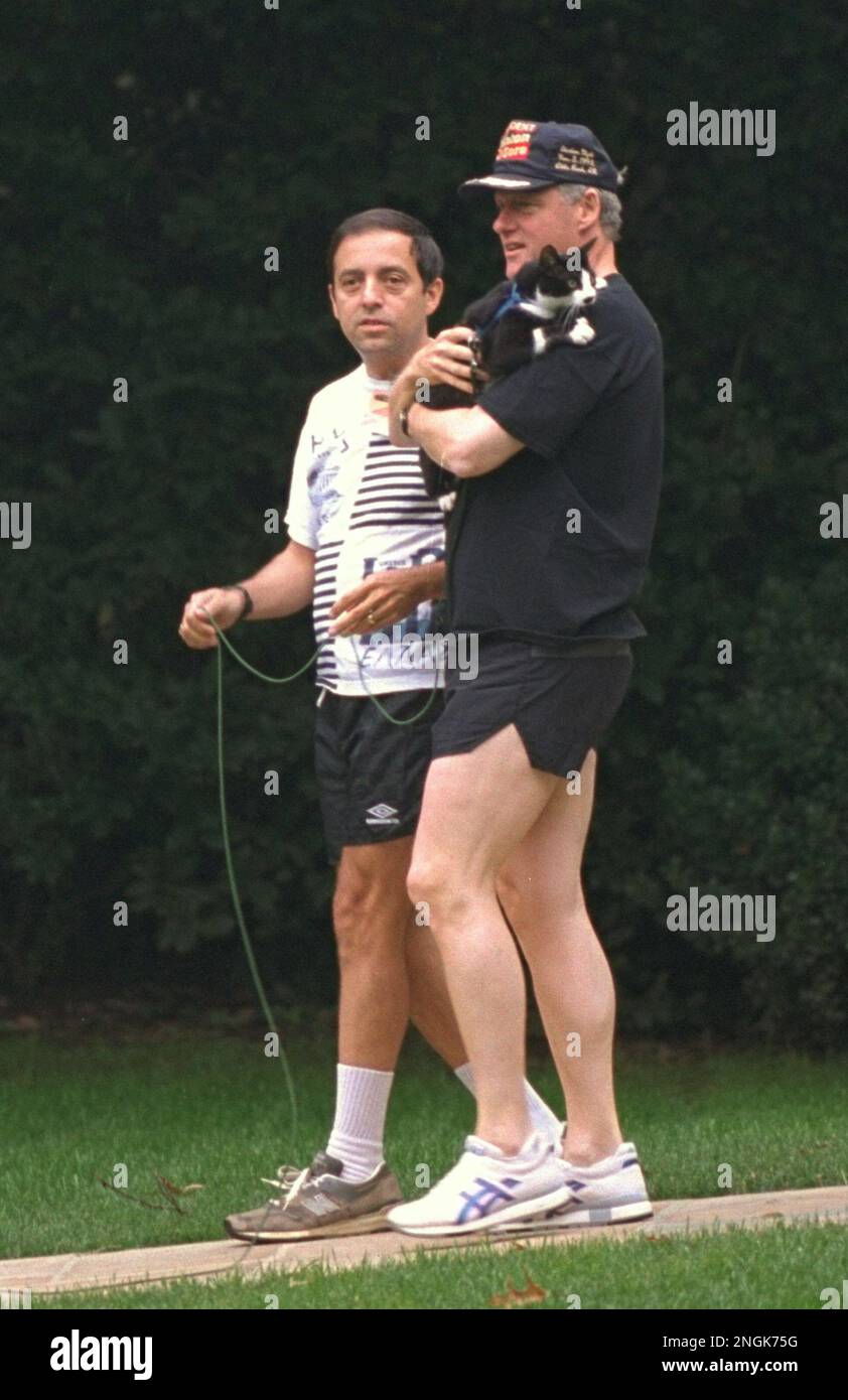 President Clinton holds Socks the cat as he and David Leopoulos, a ...
