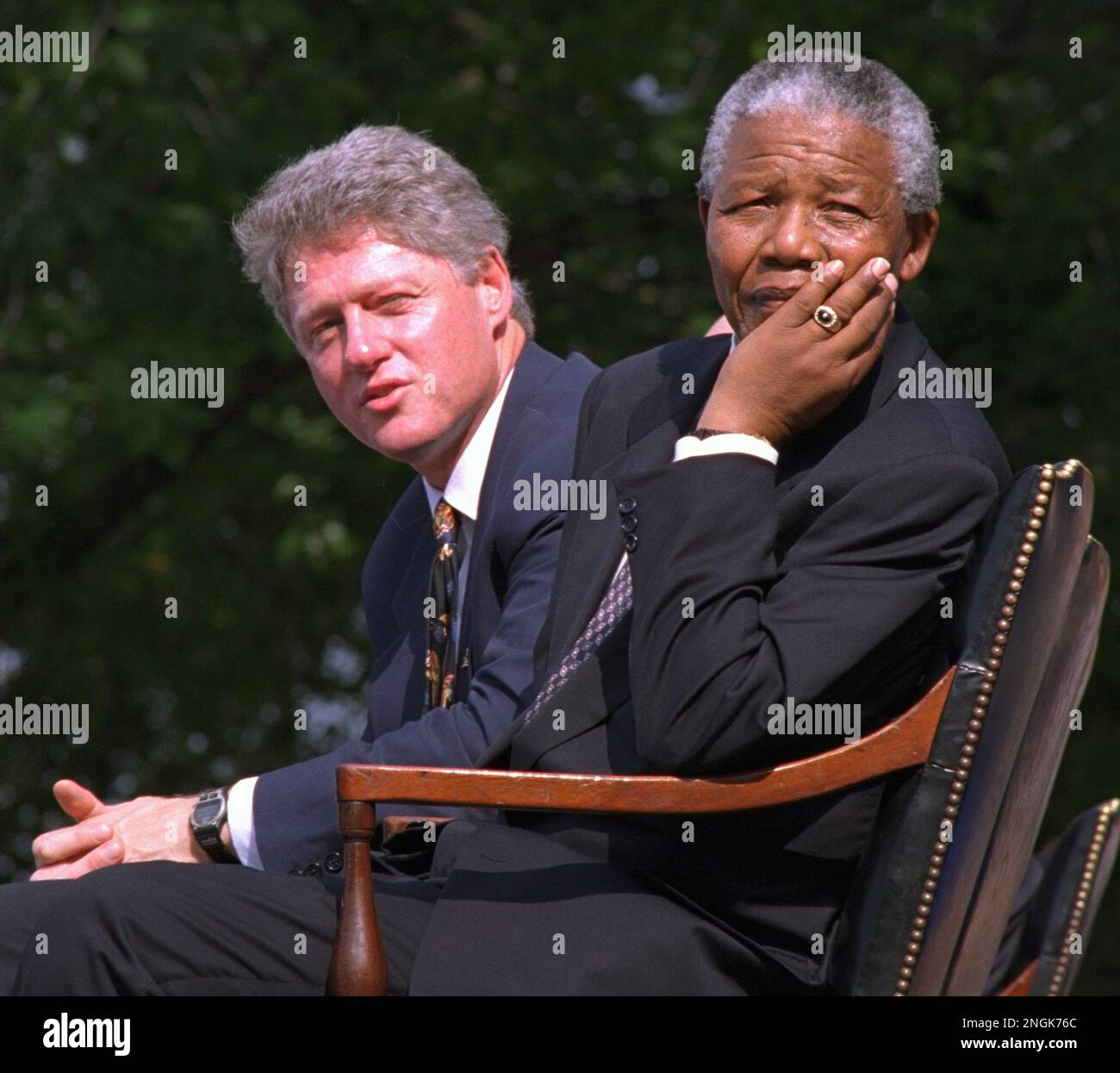 President Bill Clinton, left, and Nelson Mandela listen during Fourth of July ceremonies in ...