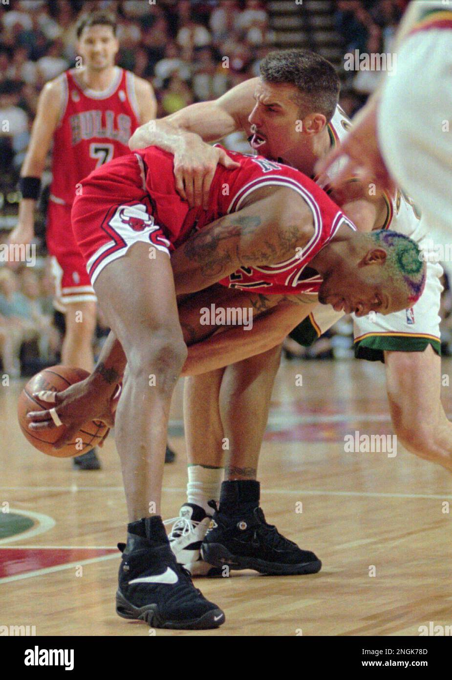 Chicago Bulls' Dennis Rodman, front, is tied up by Seattle SuperSonics ...