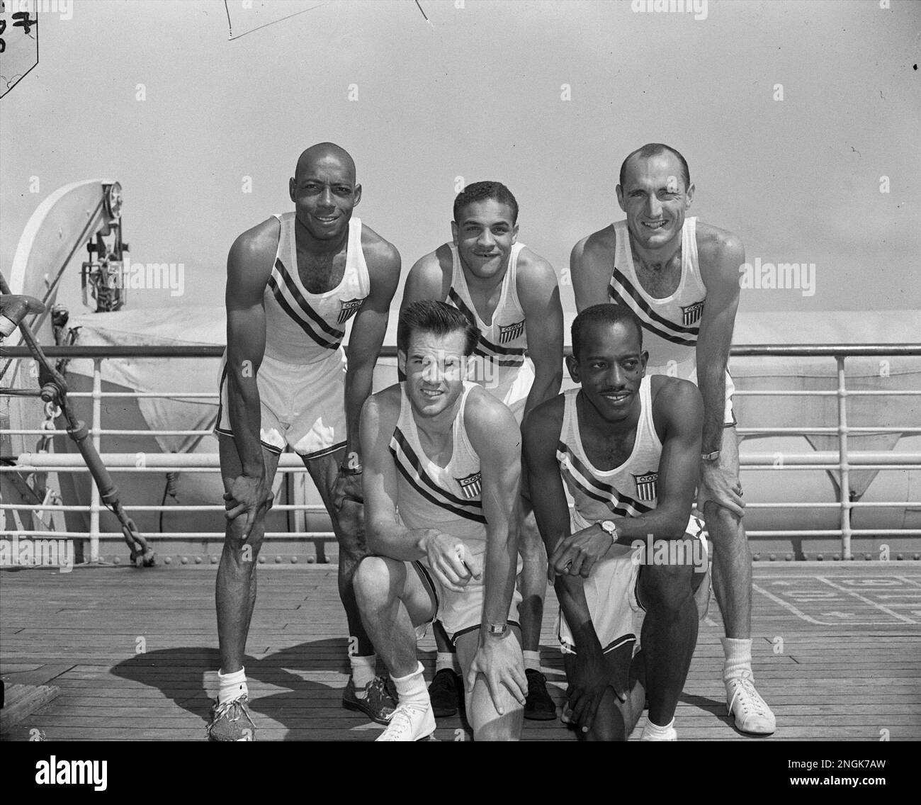 The U.S. 400-meter relay team pose on board the ocean liner "America ...