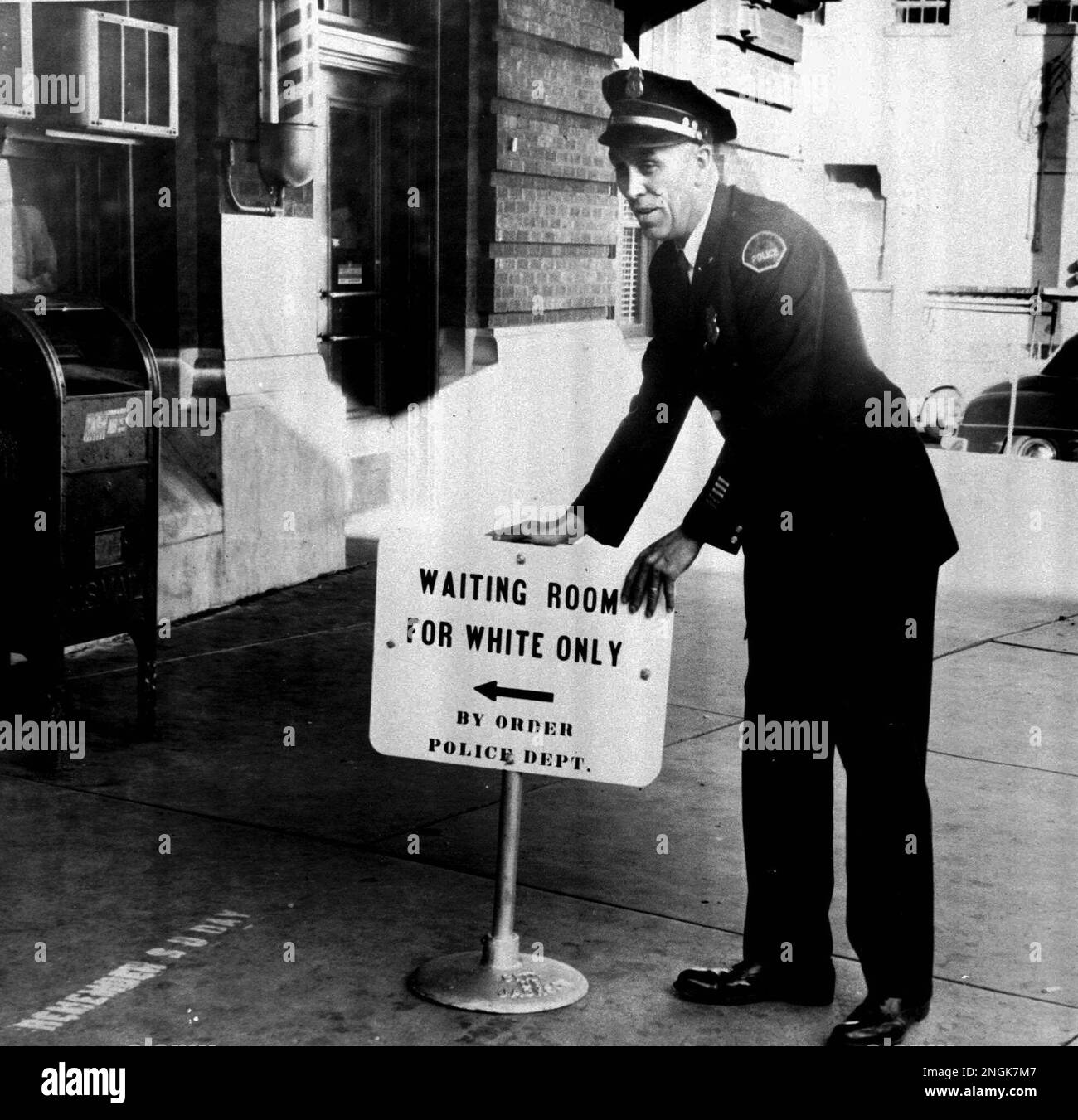 Police Lt. Beavers Armstrong places a segregation sign in front of the ...