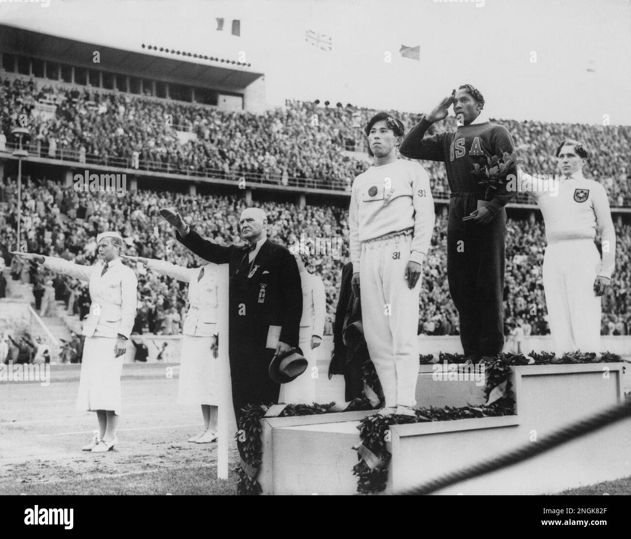 Olympic broad jump medalists salute during the medals ceremony Aug. 11 ...
