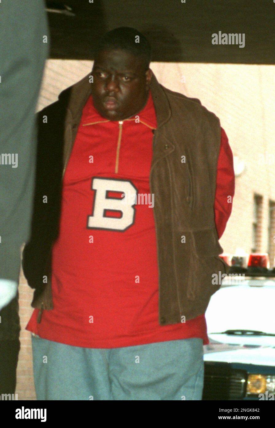 Rap star Chris Wallace aka Notorious B.I.G., walks to a waiting police ...
