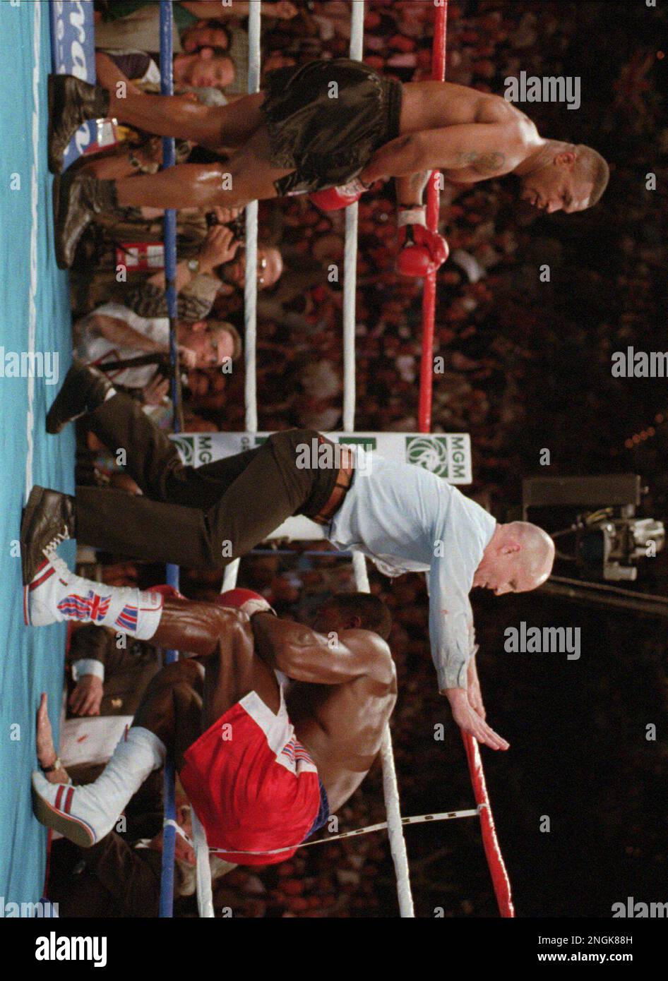 Referee Mills Lane, center, moves in and stops the fight after Mike ...