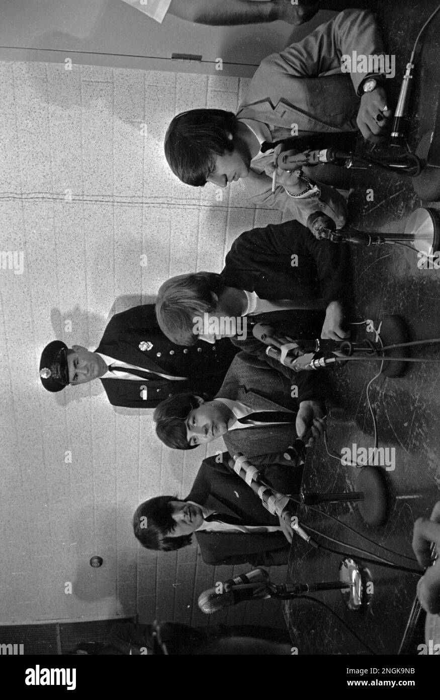The Beatles sit before a battery of michrophones in Dallas, Sept.18 ...