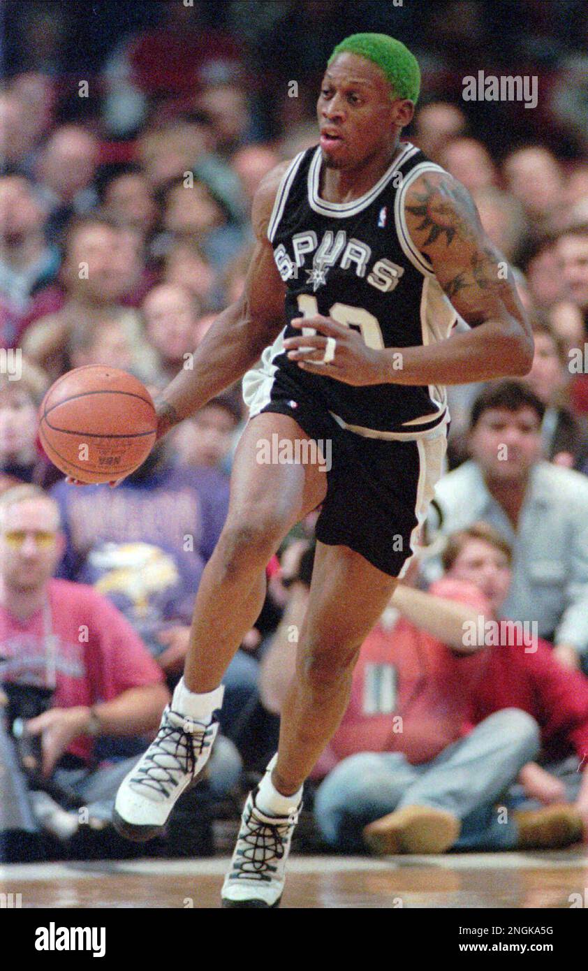 San Antonio Spurs forward Dennis Rodman brings the ball up court after ...