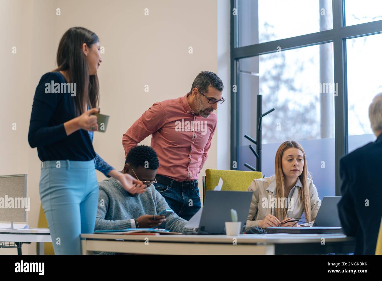 Gorgeous supervisor telling her colleagues to relax a little bit. They ...