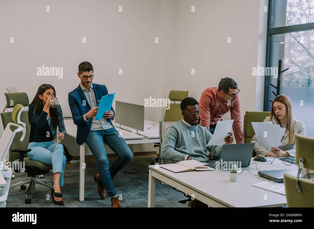 Business colleagues gathered at the table to brainstorm an idea Stock ...