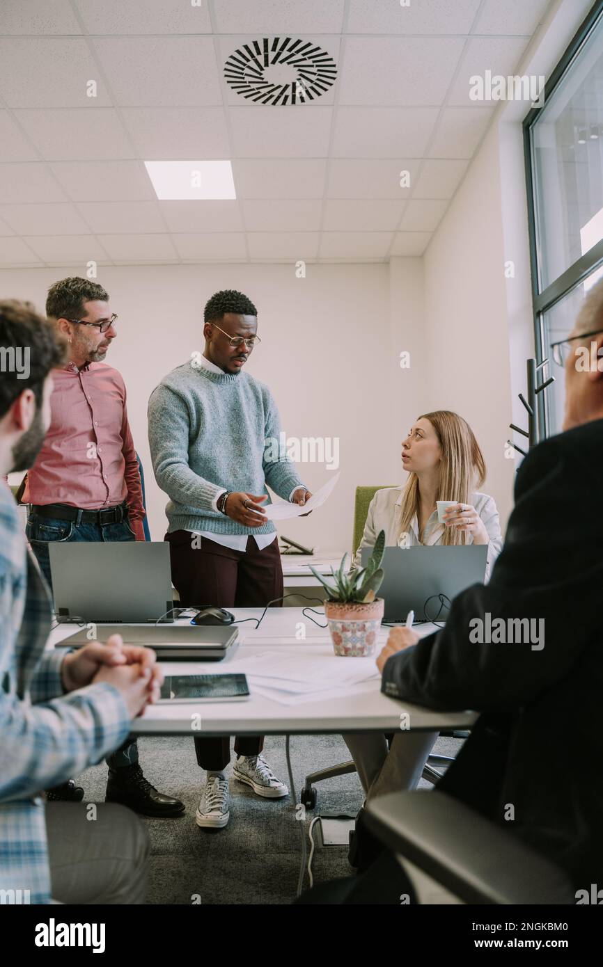 Work employee trying to get everyone’s attention and show them ...