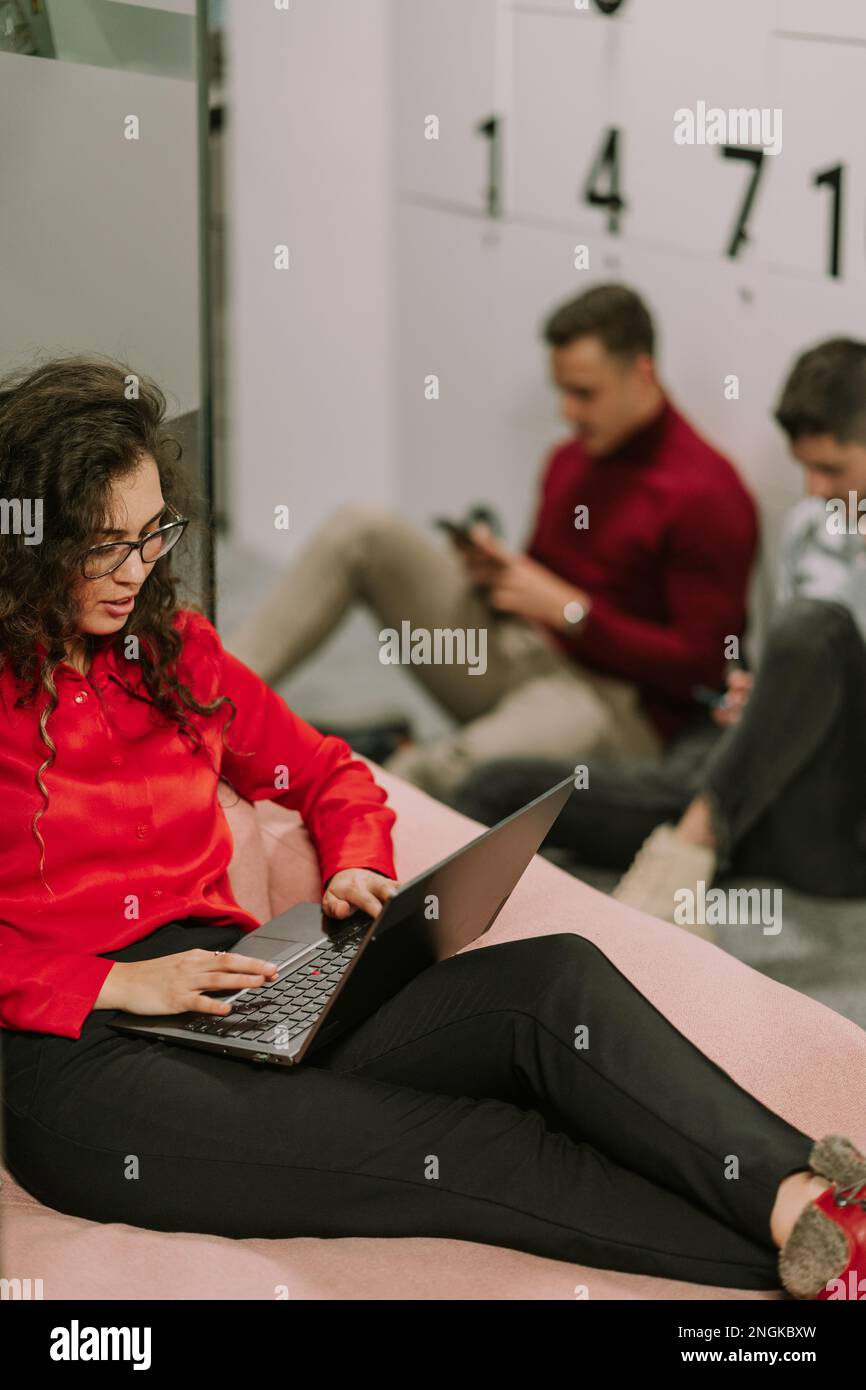 A photo of lovely business girl working on her lap top at modern office ...