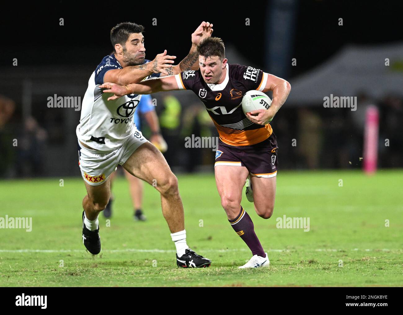 Jock Madden (right) of the Broncos gets past James Tamou (left) of the ...