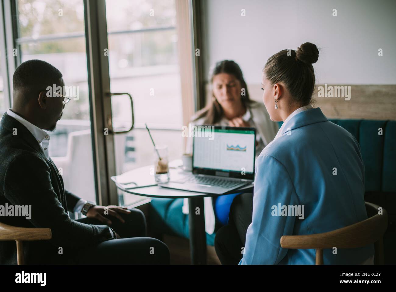 Three business people having a conversation at the cafe Stock Photo - Alamy