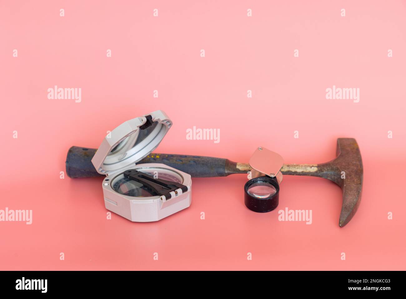 Geological fieldwork tools: hammer, compass, magnifying glass, rock ...