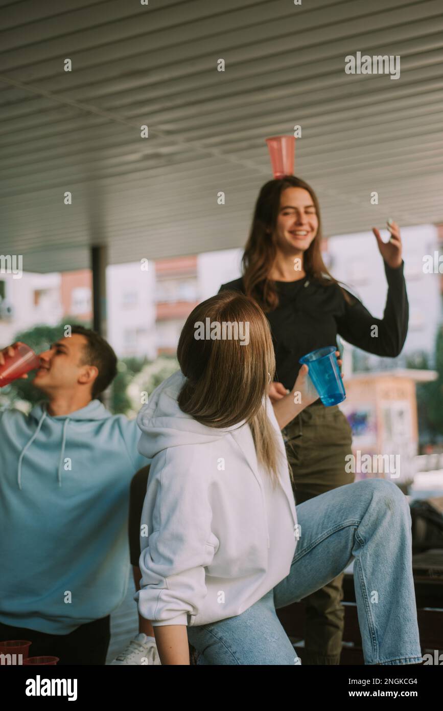 Three friends having fun while dinking at the park Stock Photo - Alamy