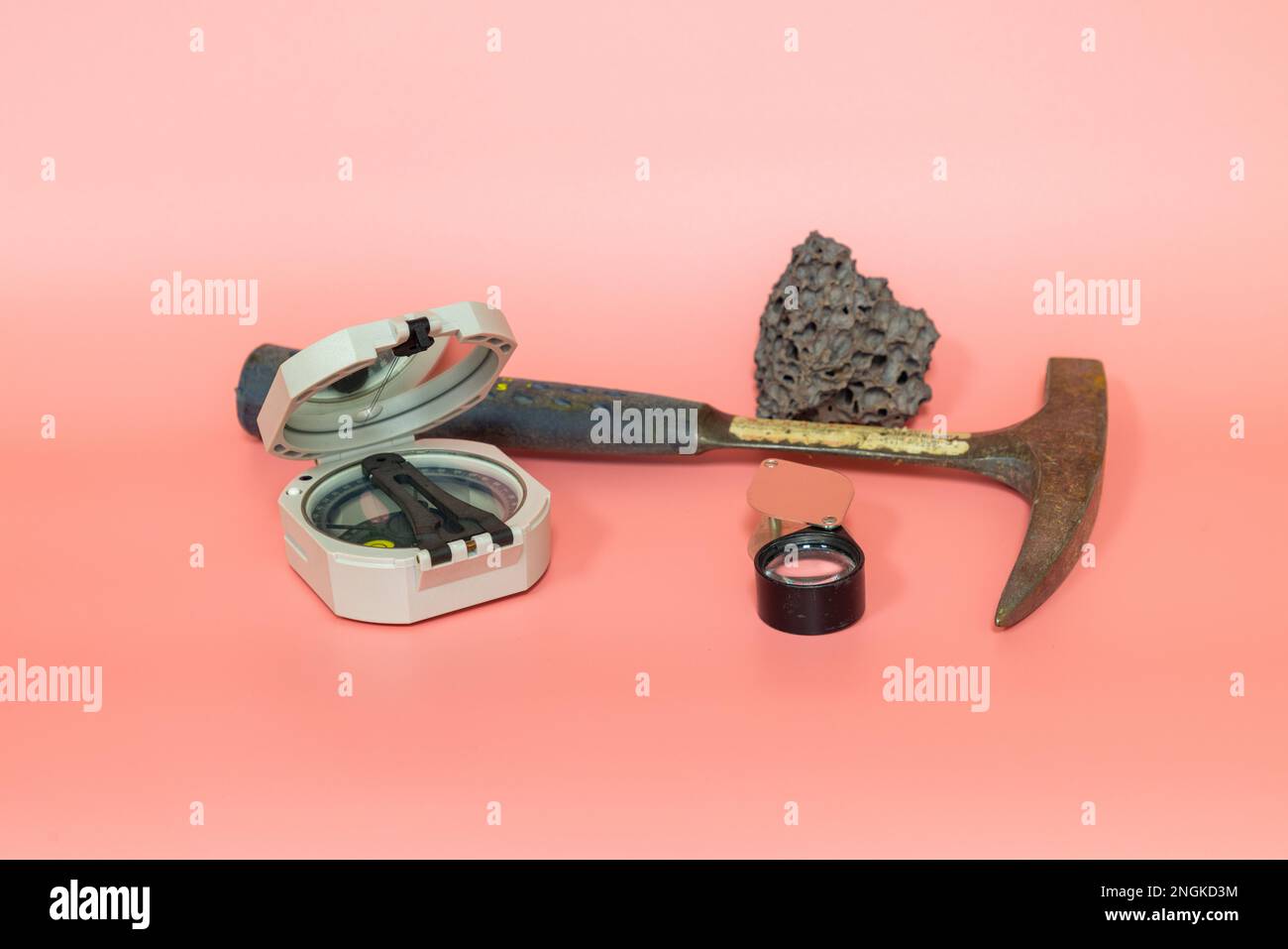 Geological fieldwork tools: hammer, compass, magnifying glass, rock ...
