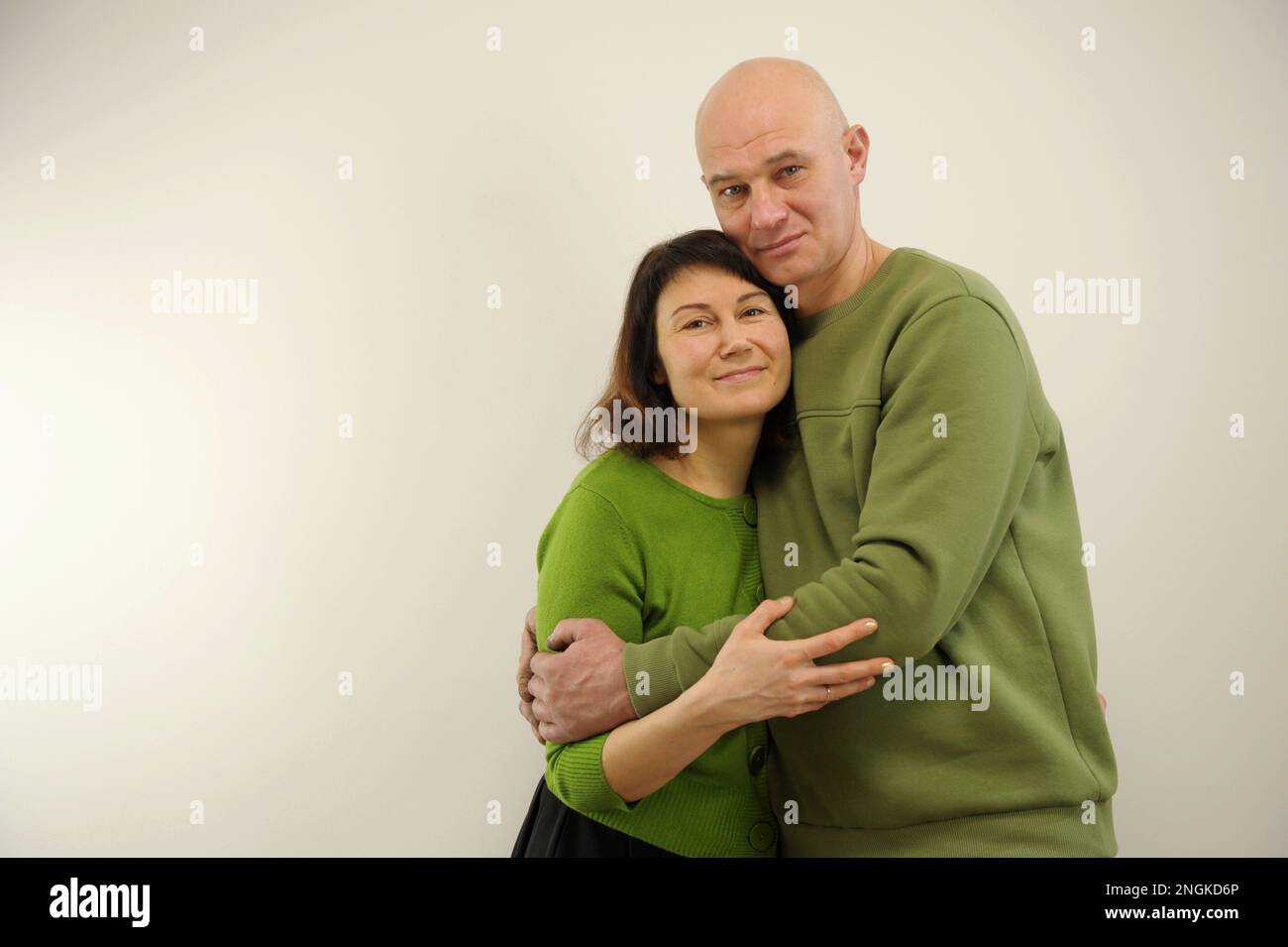 middle-aged couple hugging holding hands woman black-haired man bald ...
