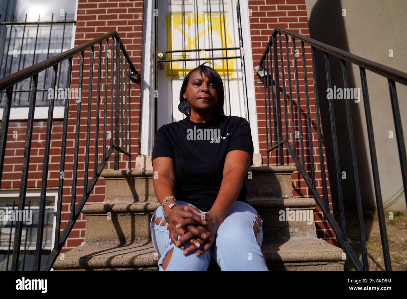 Angela Banks poses for a photograph in front of the house she used to ...