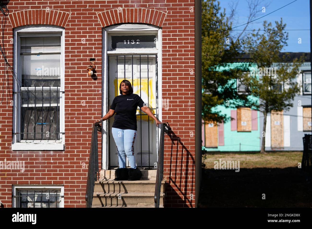 Angela Banks poses for a photograph in front of the house she used to ...