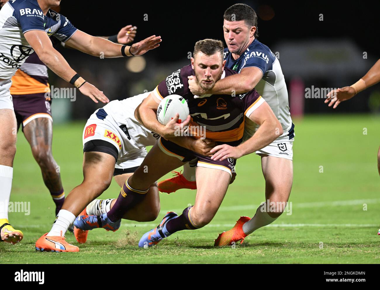 Kurt Capewell (centre) of the Broncos is tackled by Chad Townsend ...