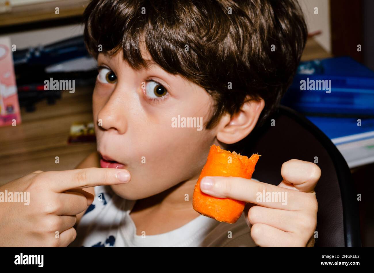 Boy eating carrot hi-res stock photography and images - Alamy
