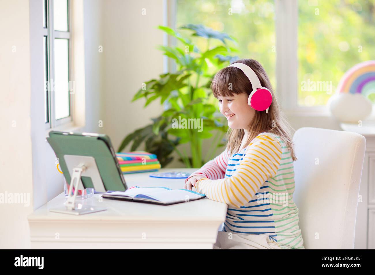 Online remote learning. School kids with computer having video ...