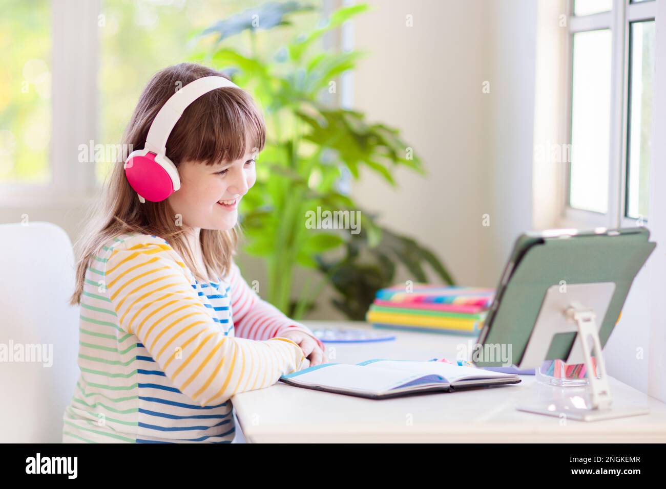 Online remote learning. School kids with computer having video ...