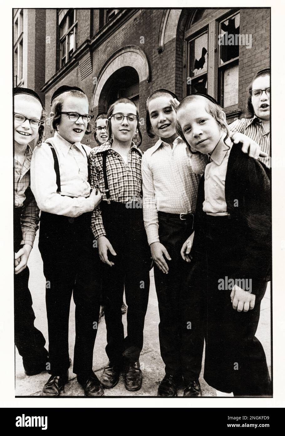 Posed portrait of orthodox Jewish boys huddled close together during ...