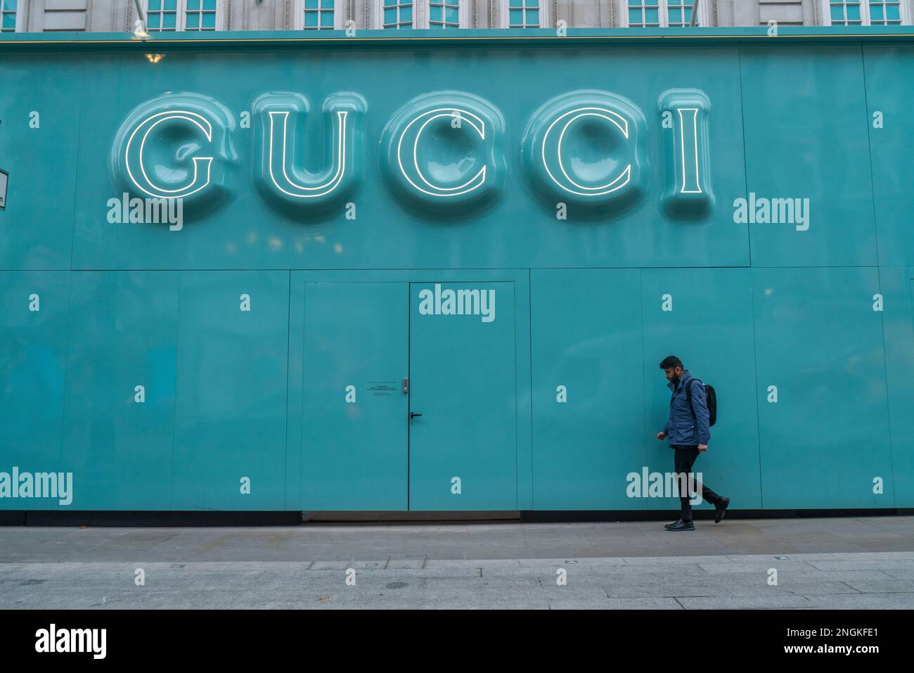London, UK. 18 February 2023. Pedestrians walk past the large signage ...