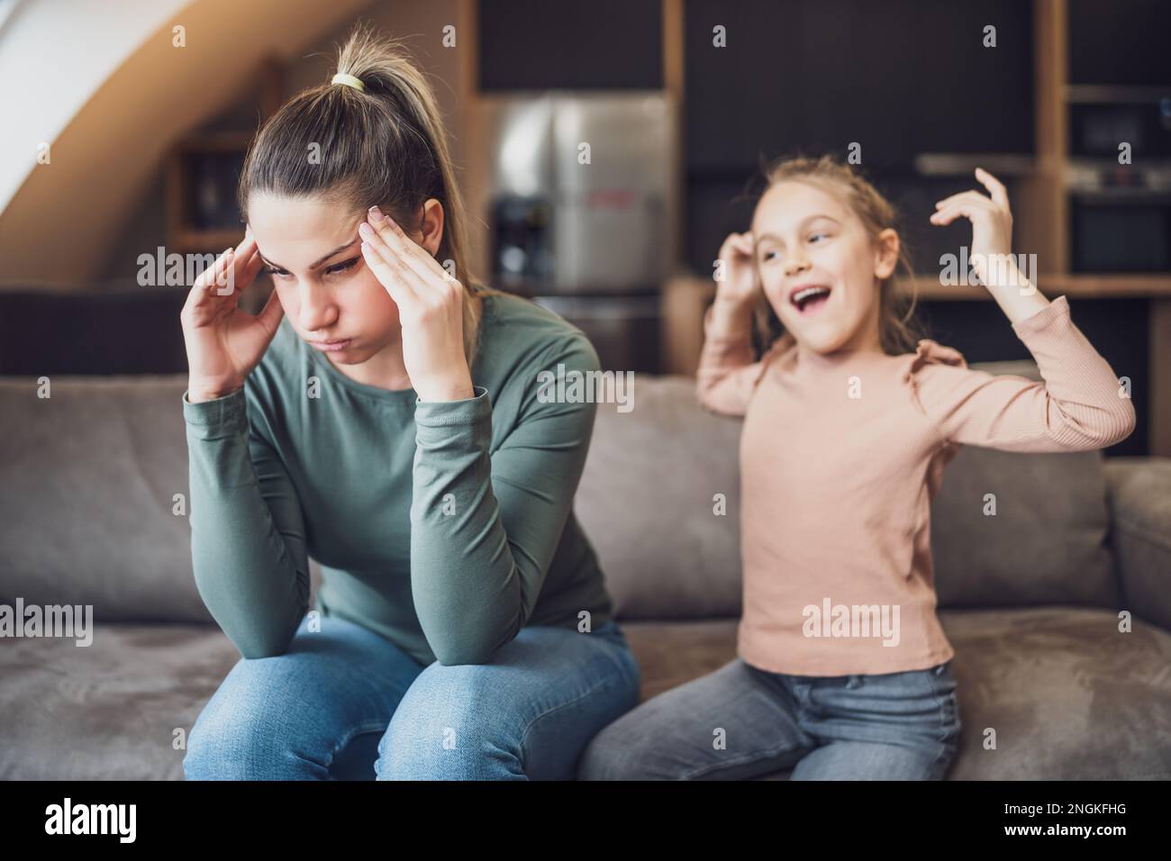 Stressed mother is feeling desperate because of screaming her daughter ...