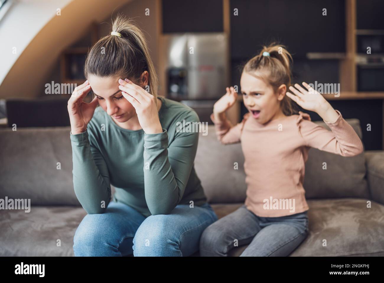 Stressed Mother Is Feeling Desperate Because Of Screaming Her Daughter