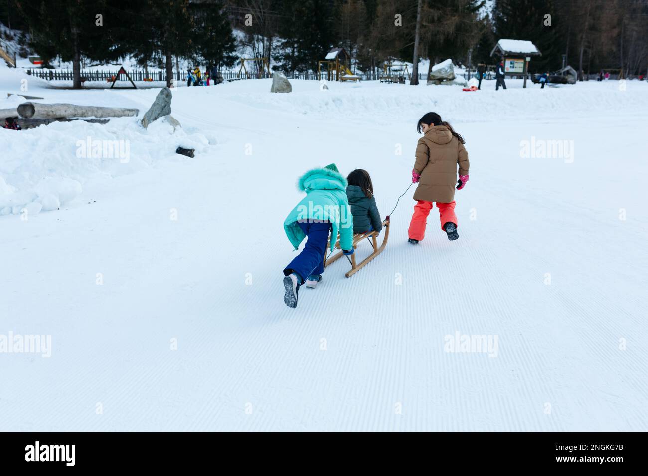 Kids pulling and pushing sled hi-res stock photography and images - Alamy
