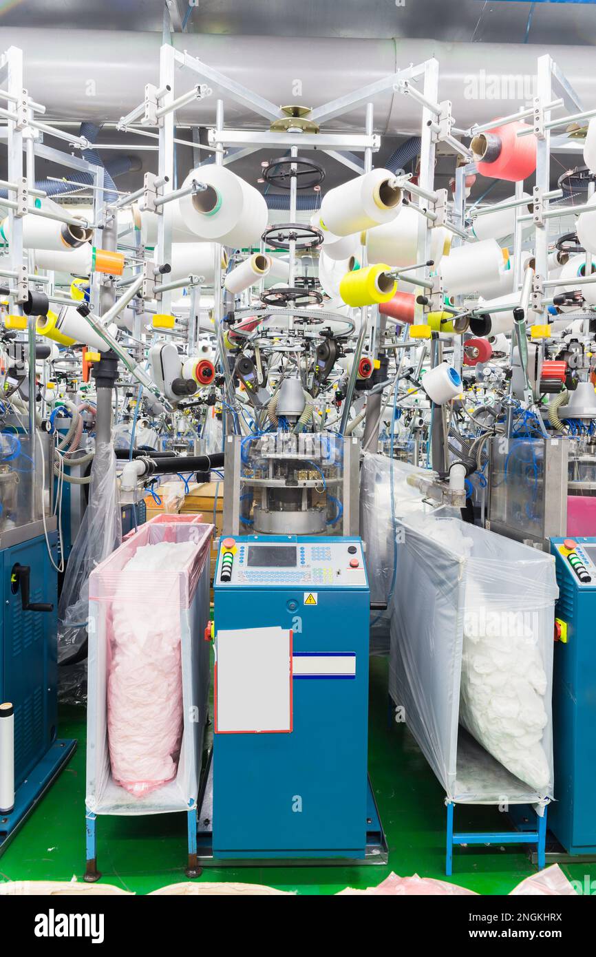 Textile industry with knitting machines in factory Stock Photo - Alamy