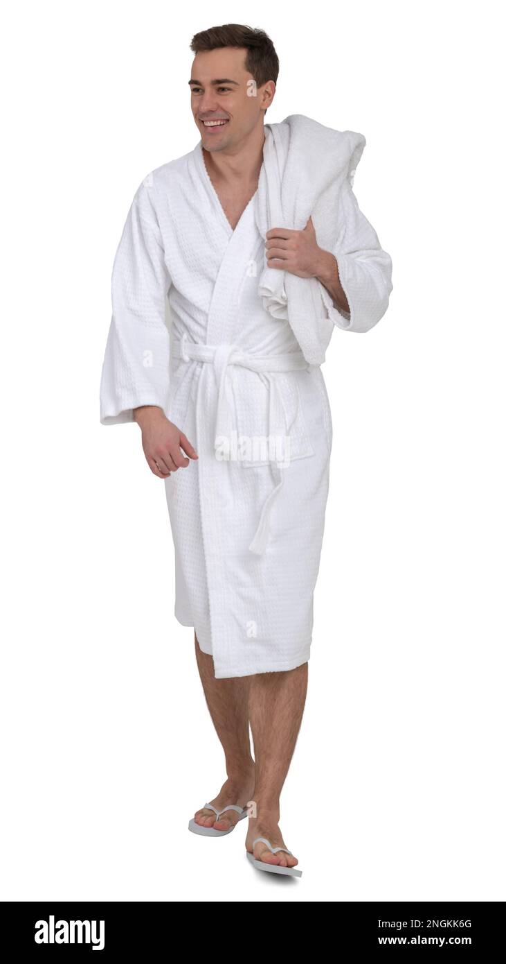 Handsome man in a white bathrobe walking and smiling isolated on white ...