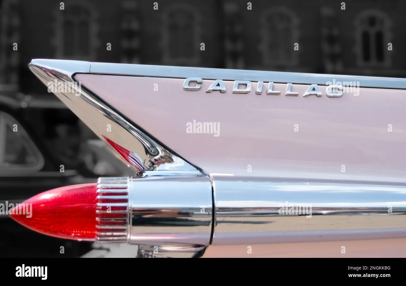 Close up of the rear wing of a pink Cadillac and red rocket rear light ...