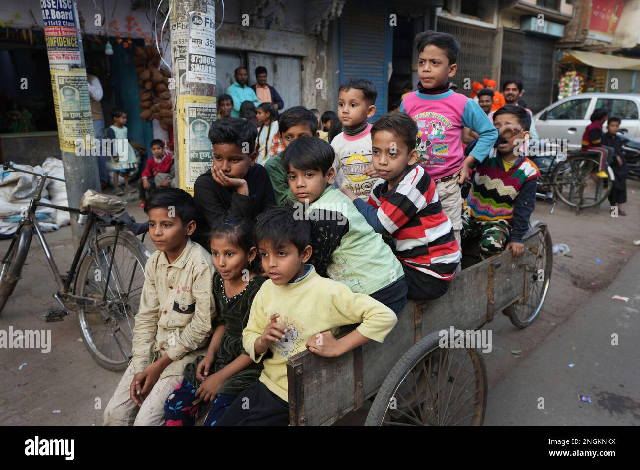 Children watch Maha Shivaratri festival procession sitting on a hand ...
