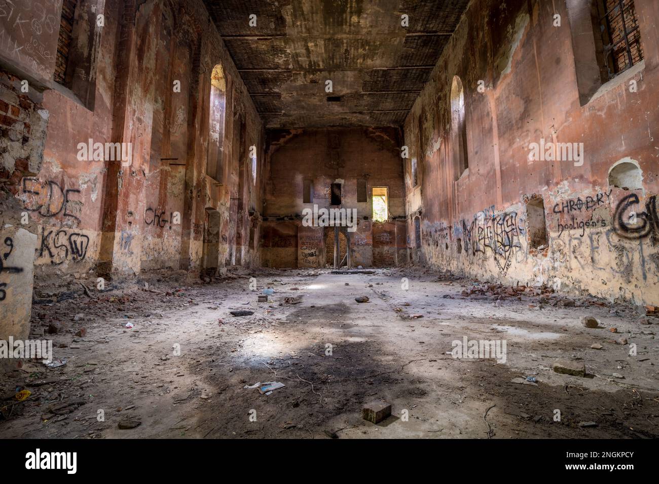 An old brick church falling into ruin standing in the bushes. Poland ...
