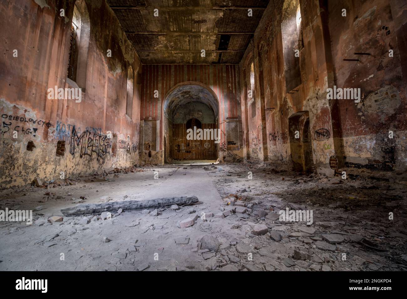 An old brick church falling into ruin standing in the bushes. Poland ...