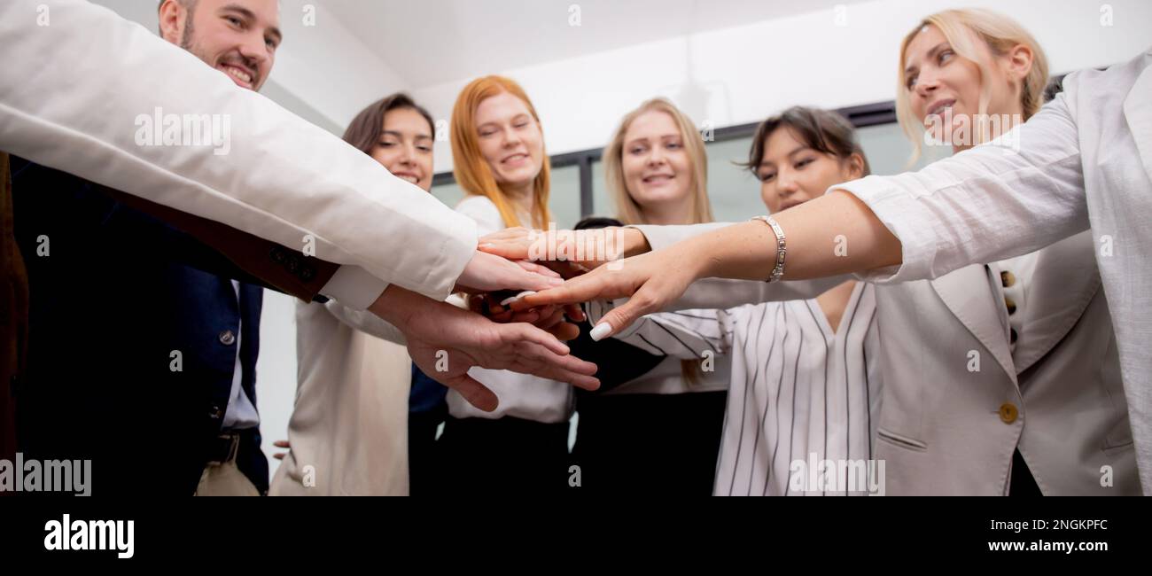 Group of business team harmonious with man and woman joining hands stack together in enterprise ...