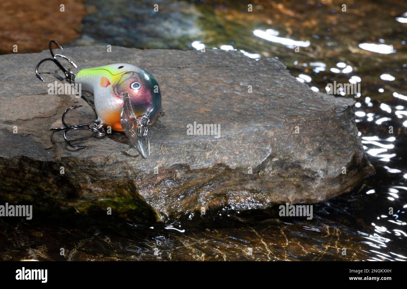 Water all around a rock and artificial fishing bait Stock Photo - Alamy
