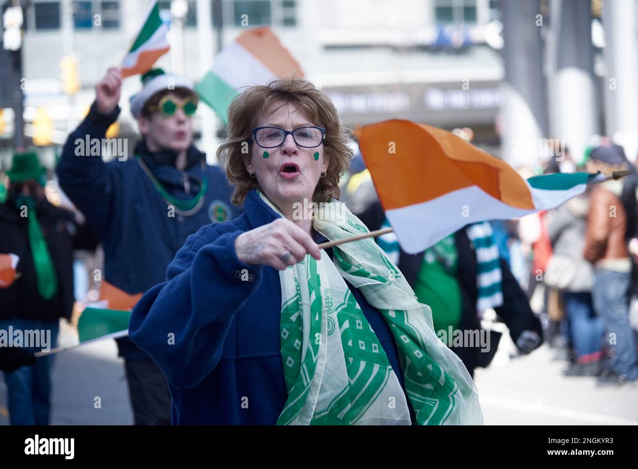 Toronto Ontario, Canada- March 20, 2022A A lady waving the Irish flag ...