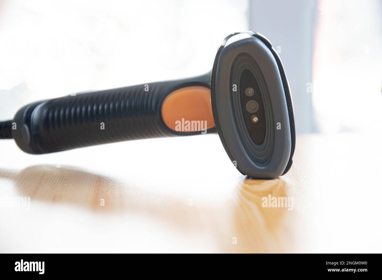 barcode scanner placed on a brown wooden floor Stock Photo - Alamy