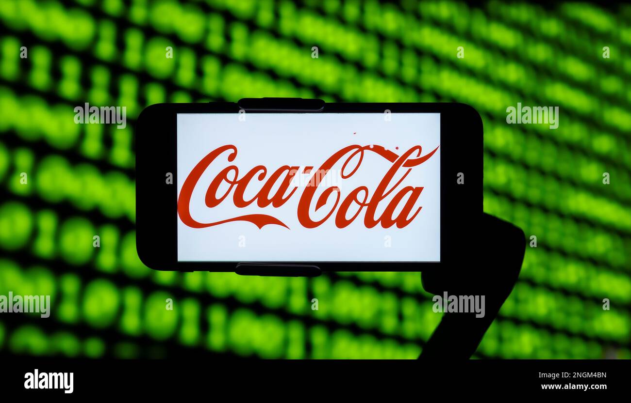 In this photo illustration, the logo of CocaCola seen displayed on a ...