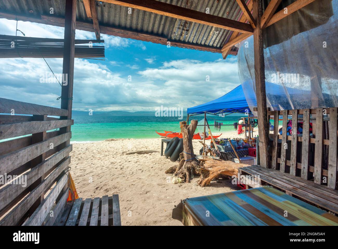 Viewed from within a shaded seating area,next to a drinks seller.A lazy ...