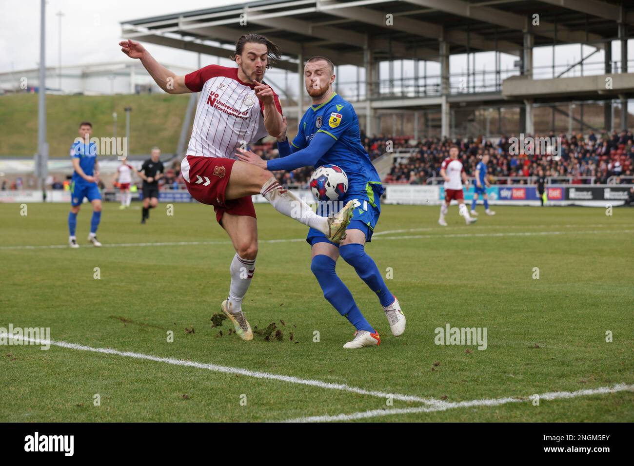 Northampton Town's Louis Appéré is challenged by Grimsby Town's Niall ...