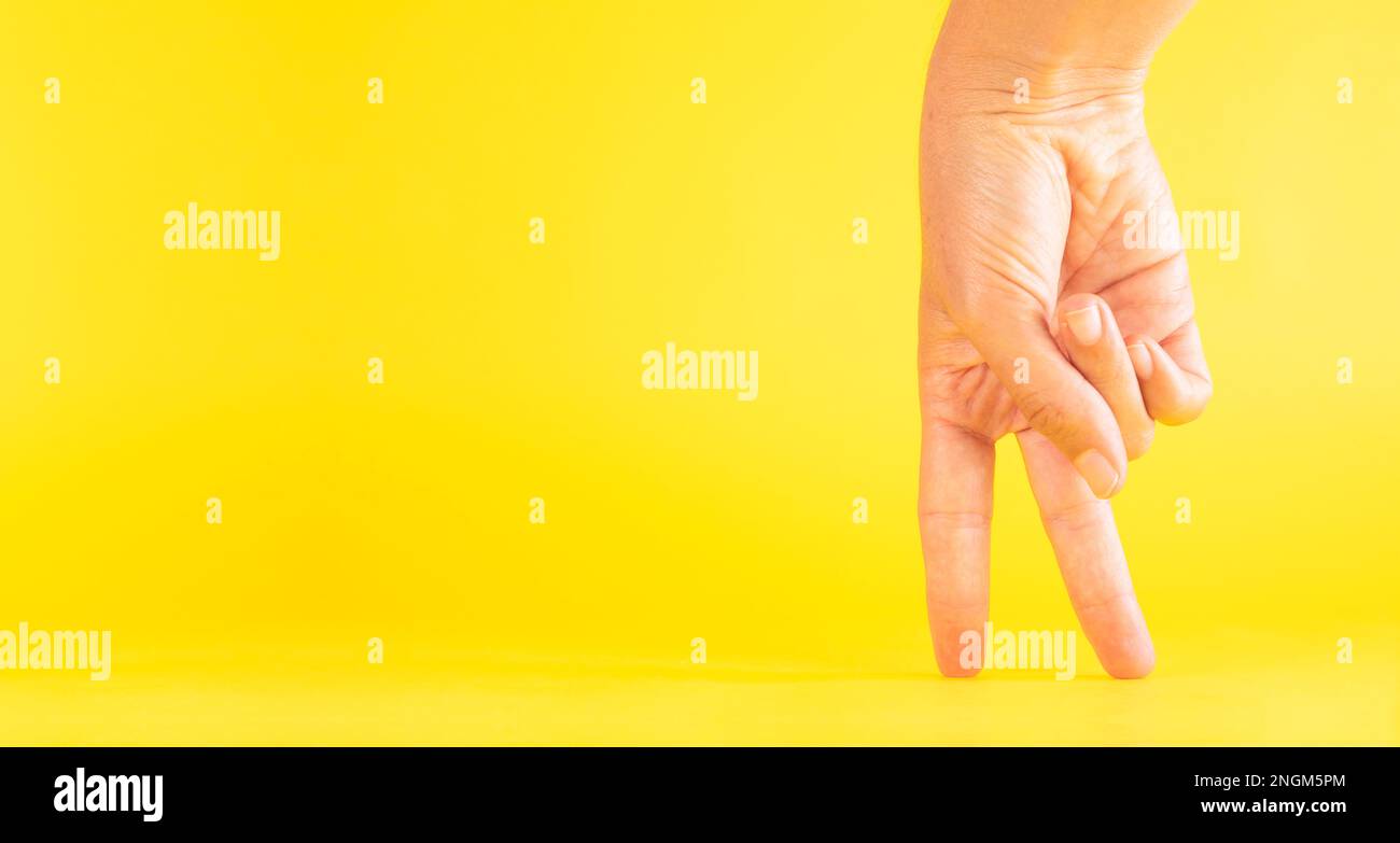 A woman's hand, imitating legs with fingers, humorously, like walking ...
